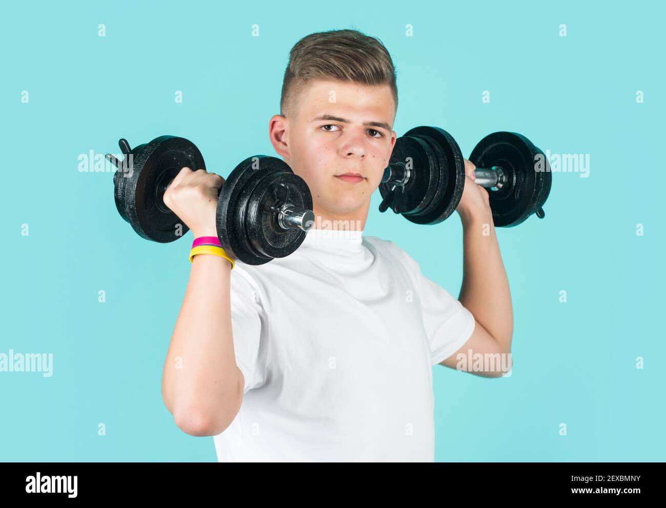 he is strong. concept of fitness. child workout with dumbbell. power ...