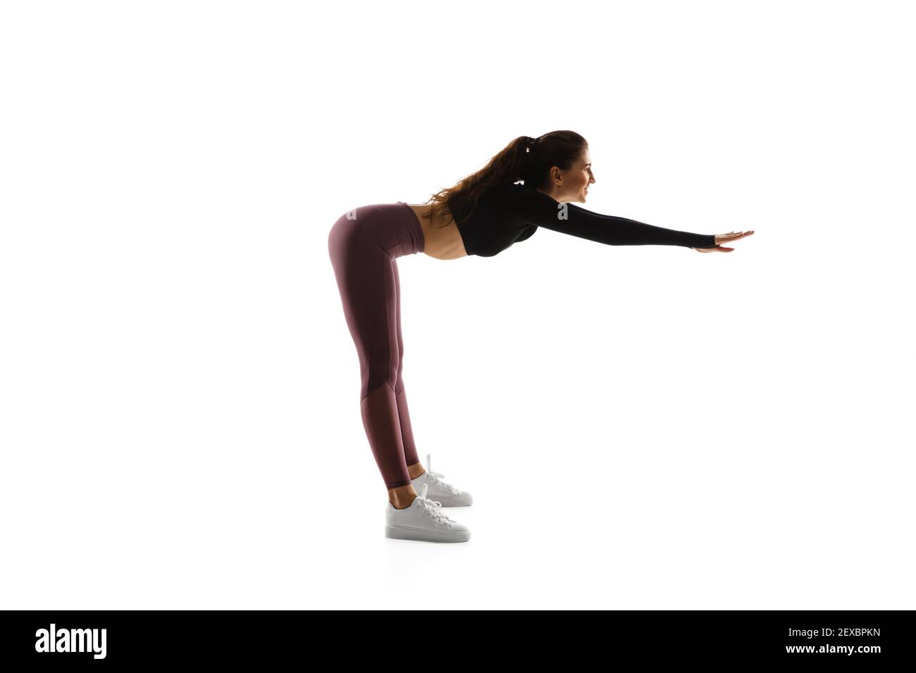 Stretching. Young caucasian female model in action, motion isolated on ...