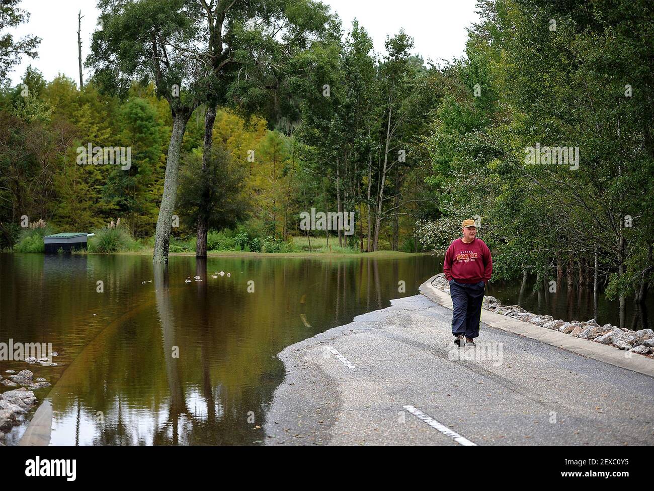 Jerry Reece, 69, turns around once he arrives at the flood-covered road ...