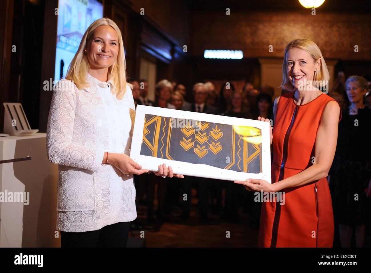 (L-R) HR Crown Princess Mette-Marit of Norway presents Caroline Baumann ...