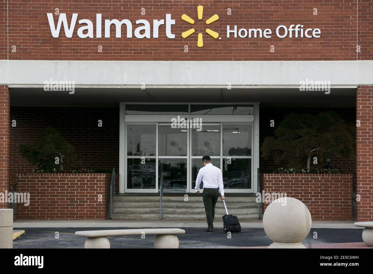 A logo sign outside of the Walmart headquarters, known as the Home ...