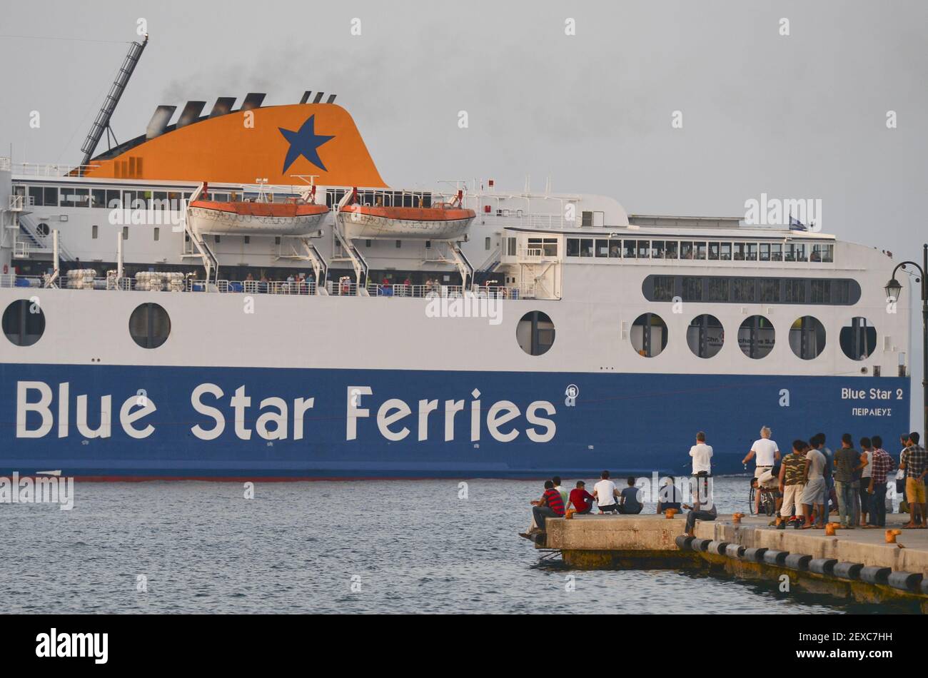 KOS, GREECE - SEPTEMBER 7, 2015 - Migrants mixed with tourists, watch ...