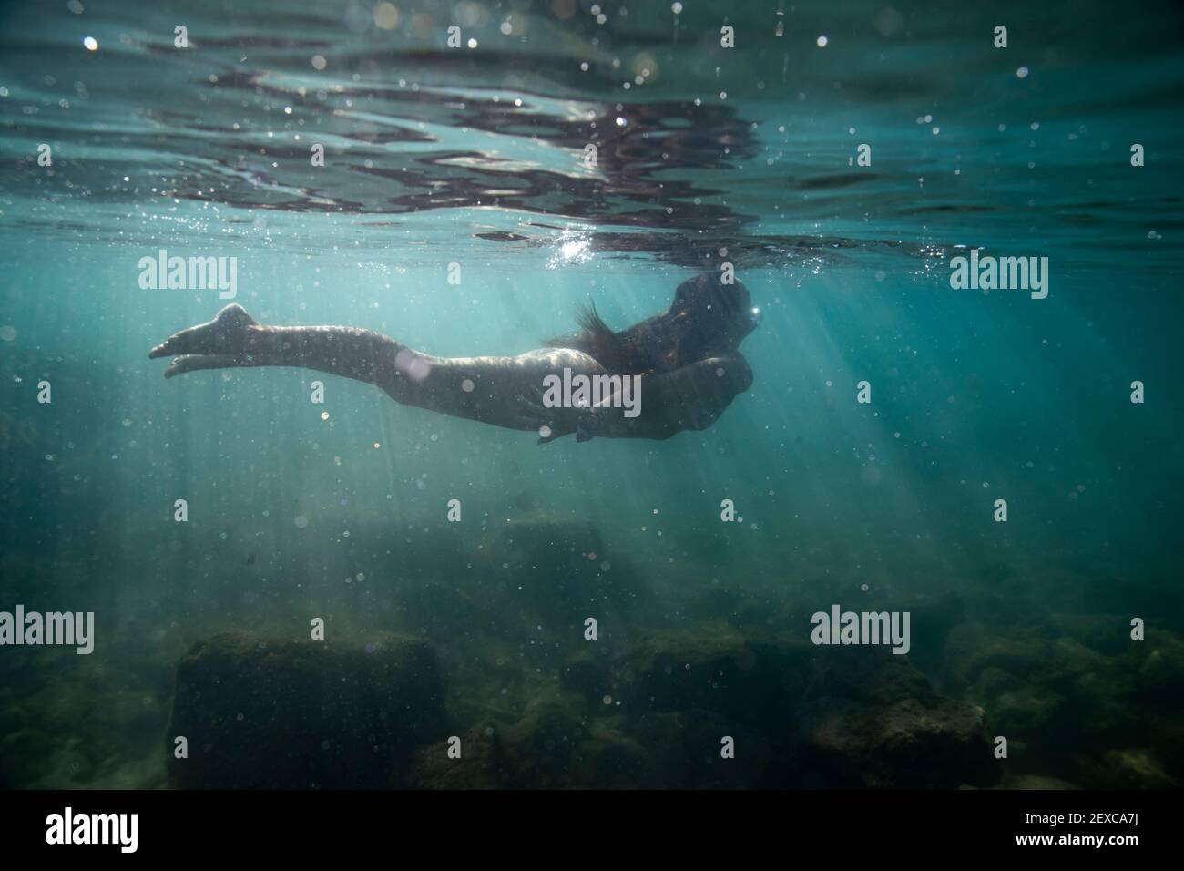Female swims just below surface hi-res stock photography and images - Alamy