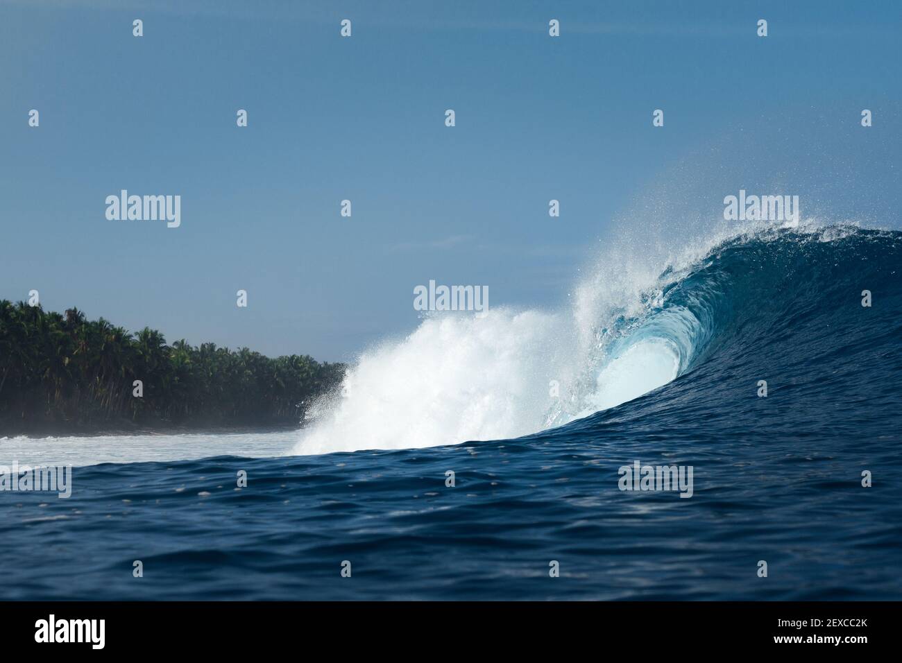 Blue and powerful wave breaking on a beach of Indonesia Stock Photo - Alamy