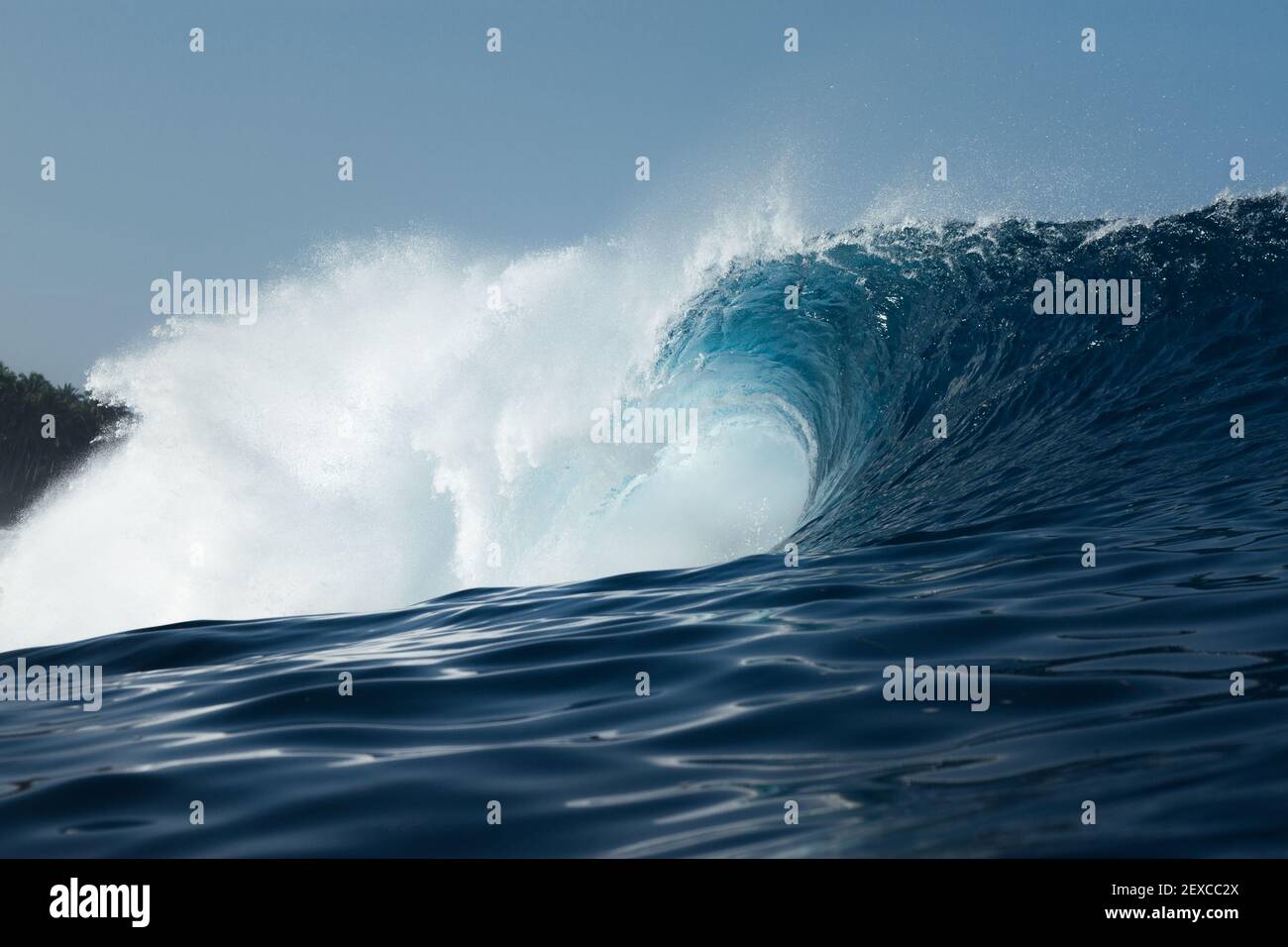 Blue and powerful wave breaking on a beach of Indonesia Stock Photo - Alamy