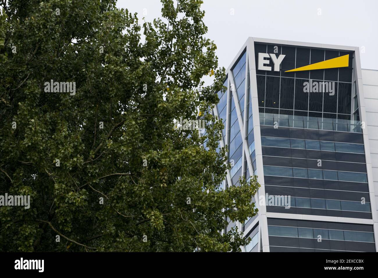 A logo sign outside of an office building occupied by Ernst & Young (EY ...