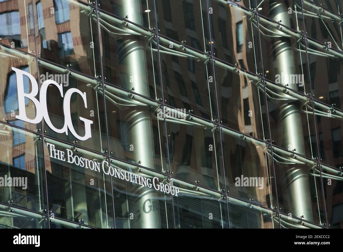 A logo sign outside of an office building occupied by The Boston ...