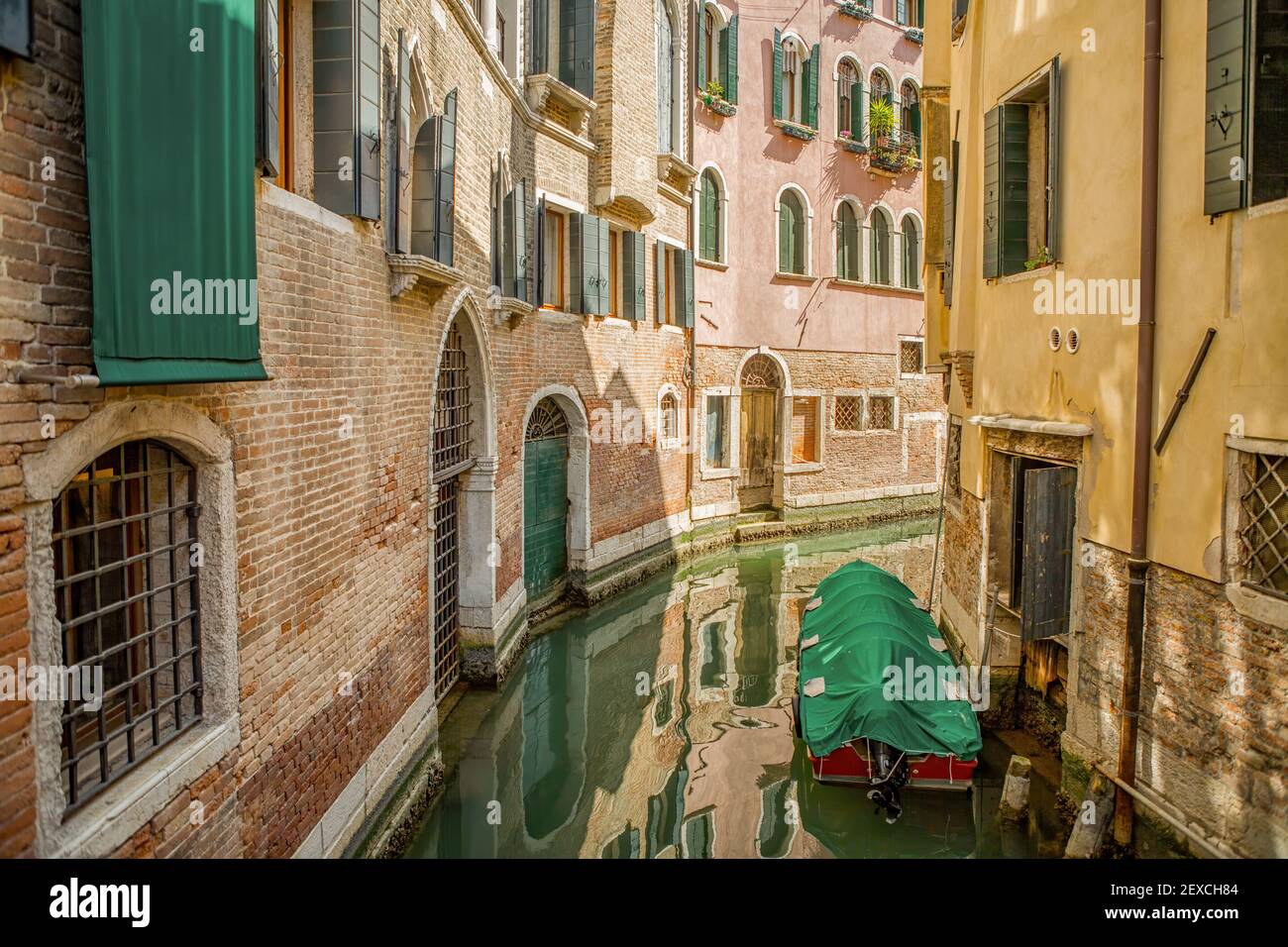 Italian waterway between the houses in Venice Stock Photo - Alamy