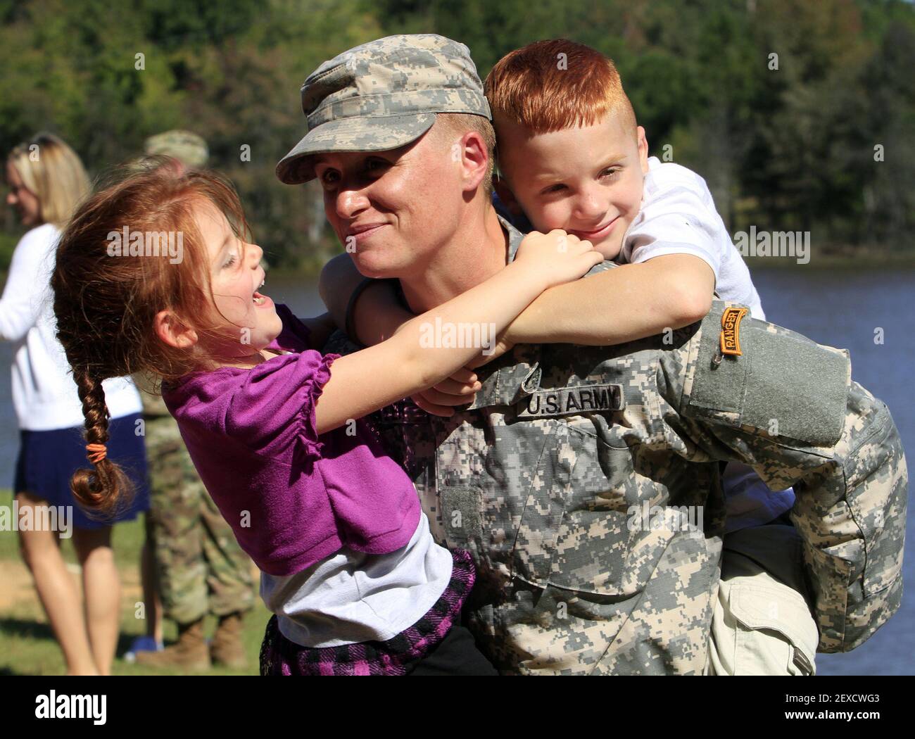 Maj. Lisa Jaster holds her daughter Victoria, 3, and her son Zachary, 7 ...