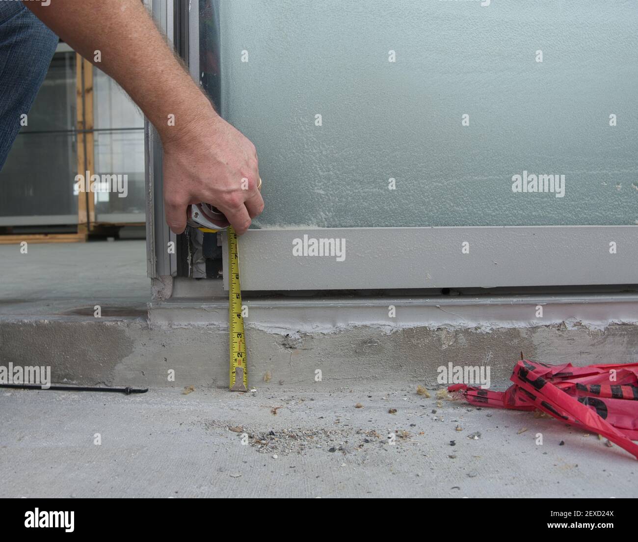 A worker measuring the height of the floor at the construction site ...