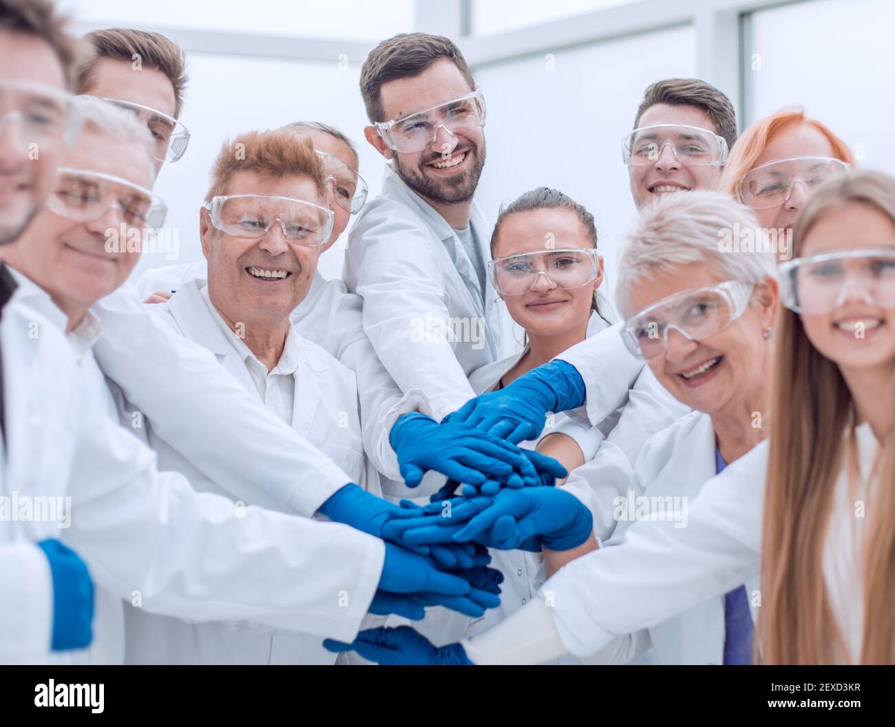 group of medical lab employees joining their palms together Stock Photo ...