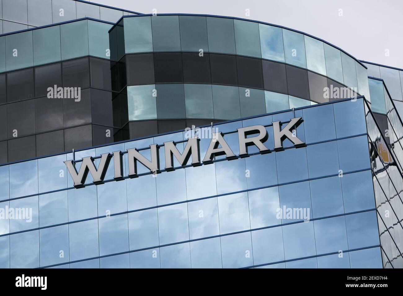 A logo sign outside of the headquarters of the Winmark Corporation in ...