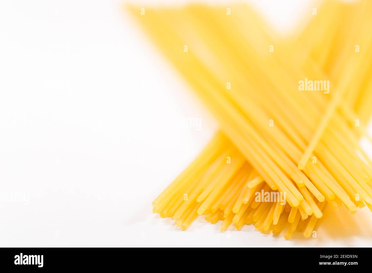 An isolated shot of uncooked spaghetti noodles on a white background ...