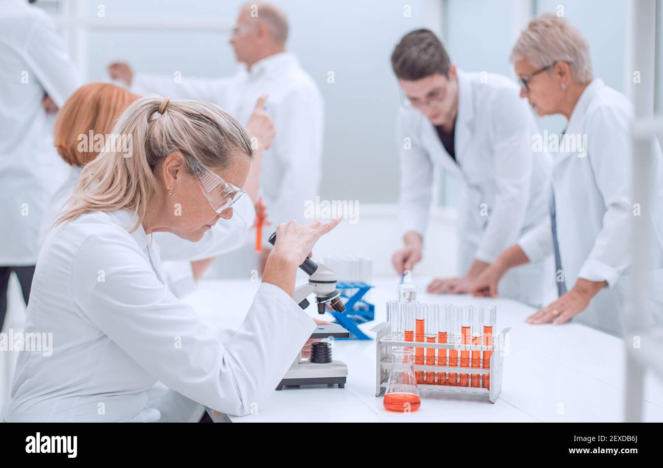 female scientist sitting at a Desk in the laboratory Stock Photo - Alamy