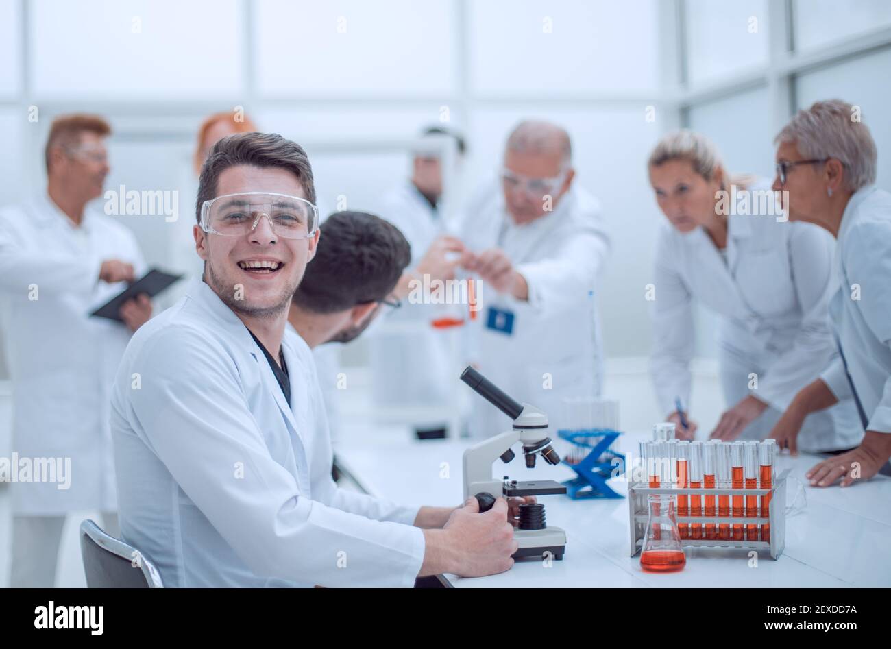 young scientist and his colleagues work in the laboratory Stock Photo ...