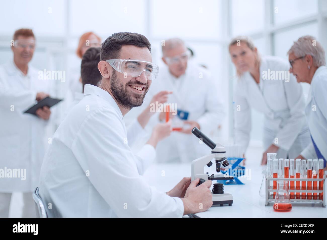 Smiling scientist sitting laboratory hi-res stock photography and ...