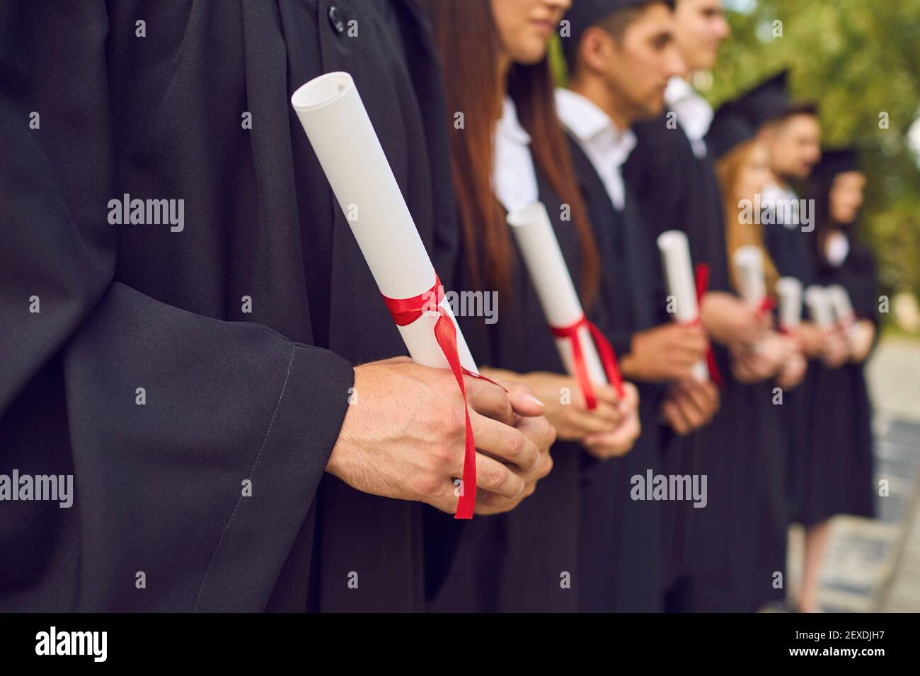 University graduates hands holding diplomas after university graduating ...