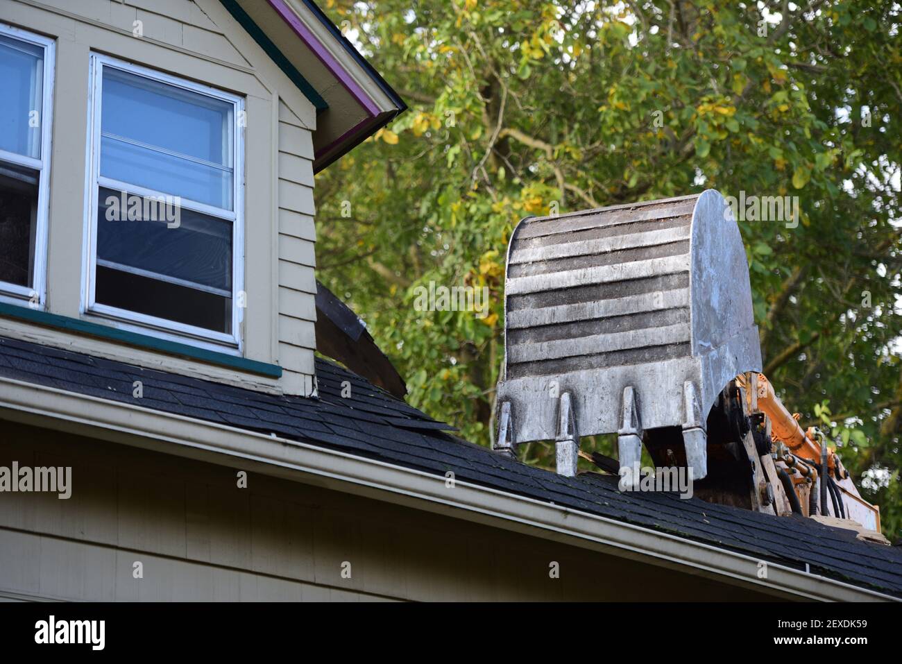 A demolition crew with Dan Riehl Excavating tears down a house at 633 ...