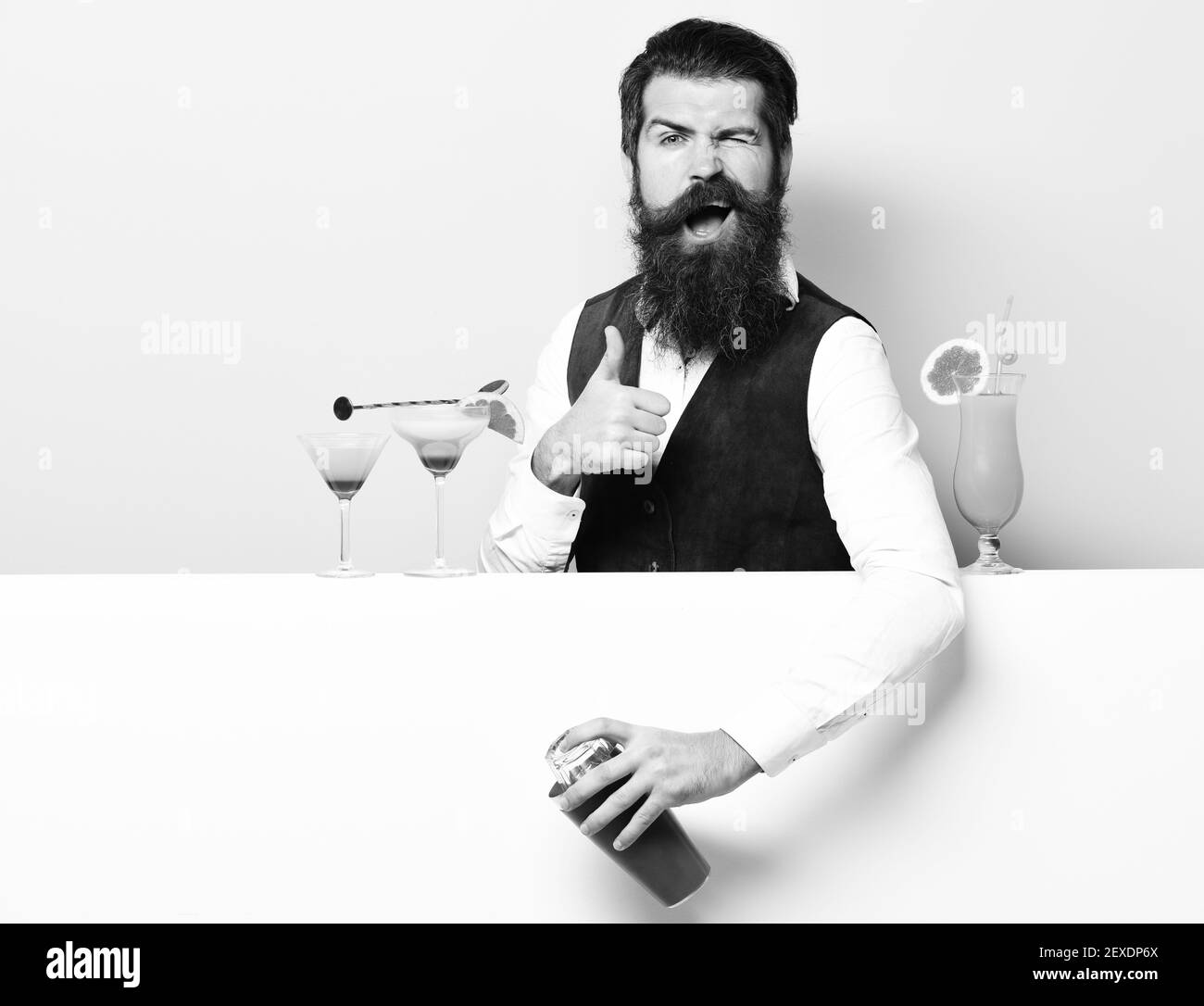 handsome bearded barman with long beard and mustache has stylish hair ...