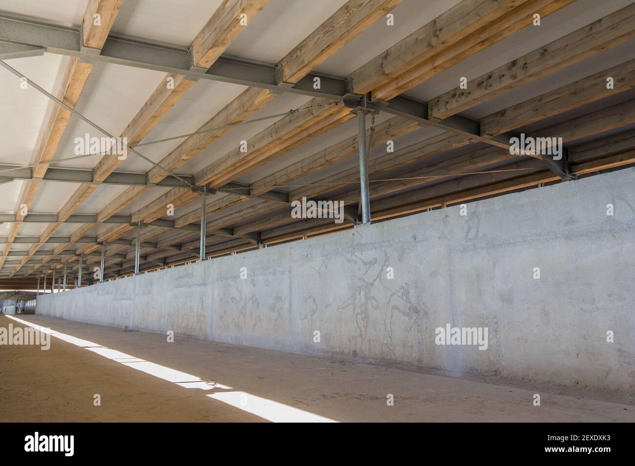 The roof structure of a large hangar consists of a steel frame and ...