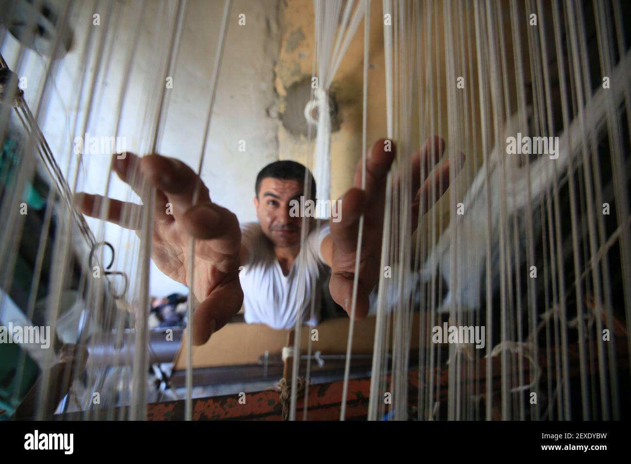 A Palestinian man AL Sawaf works on the old machine Loom carpet ...