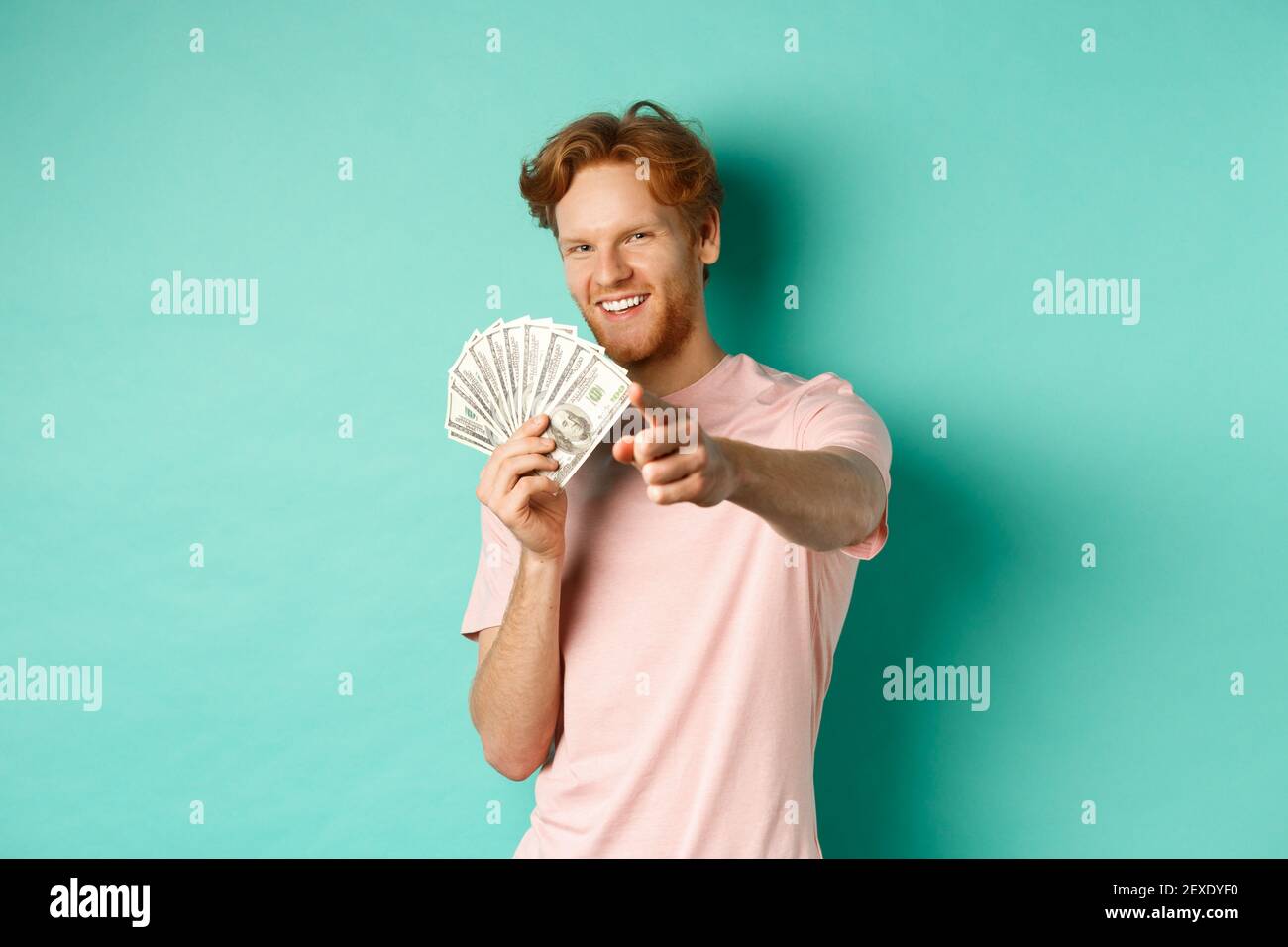 Handsome and confident redhead guy pointing finger at you, showing ...