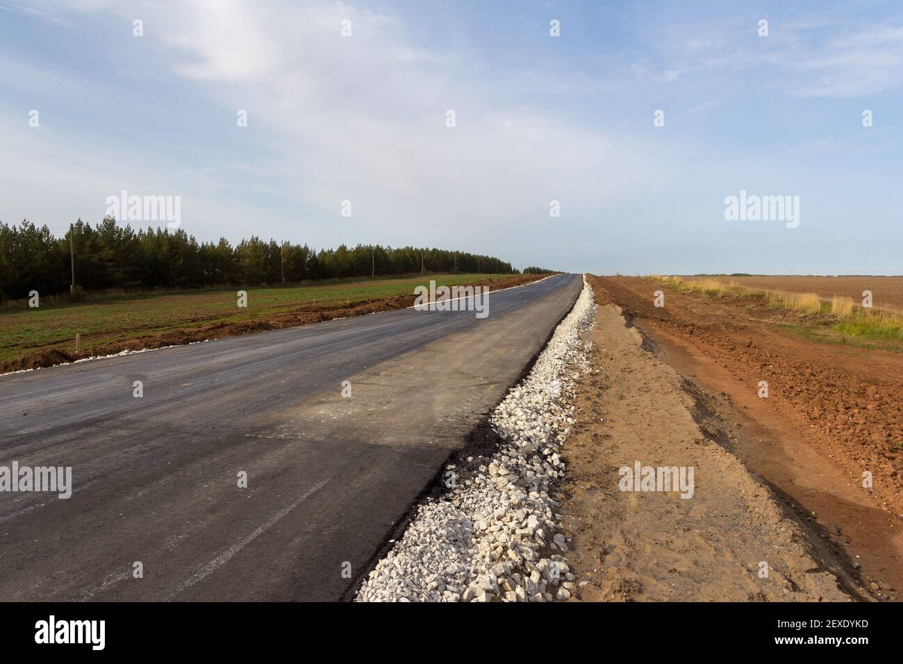 Construction of a new road. Construction stage. Road pavement layers ...