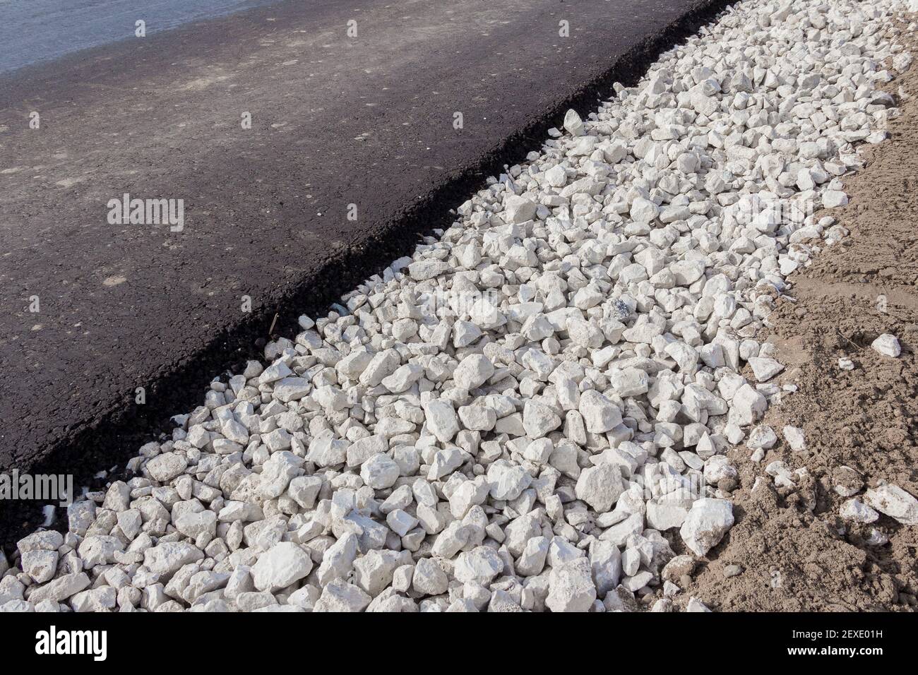 New motor road. Paved bituminous asphalt based on gravel. Road layers ...