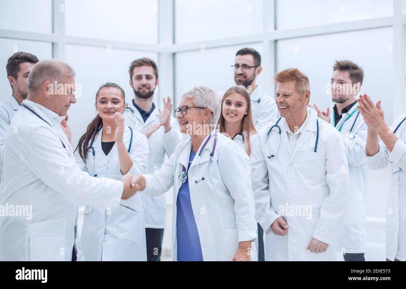 happy medical colleagues shaking hands with each other Stock Photo - Alamy