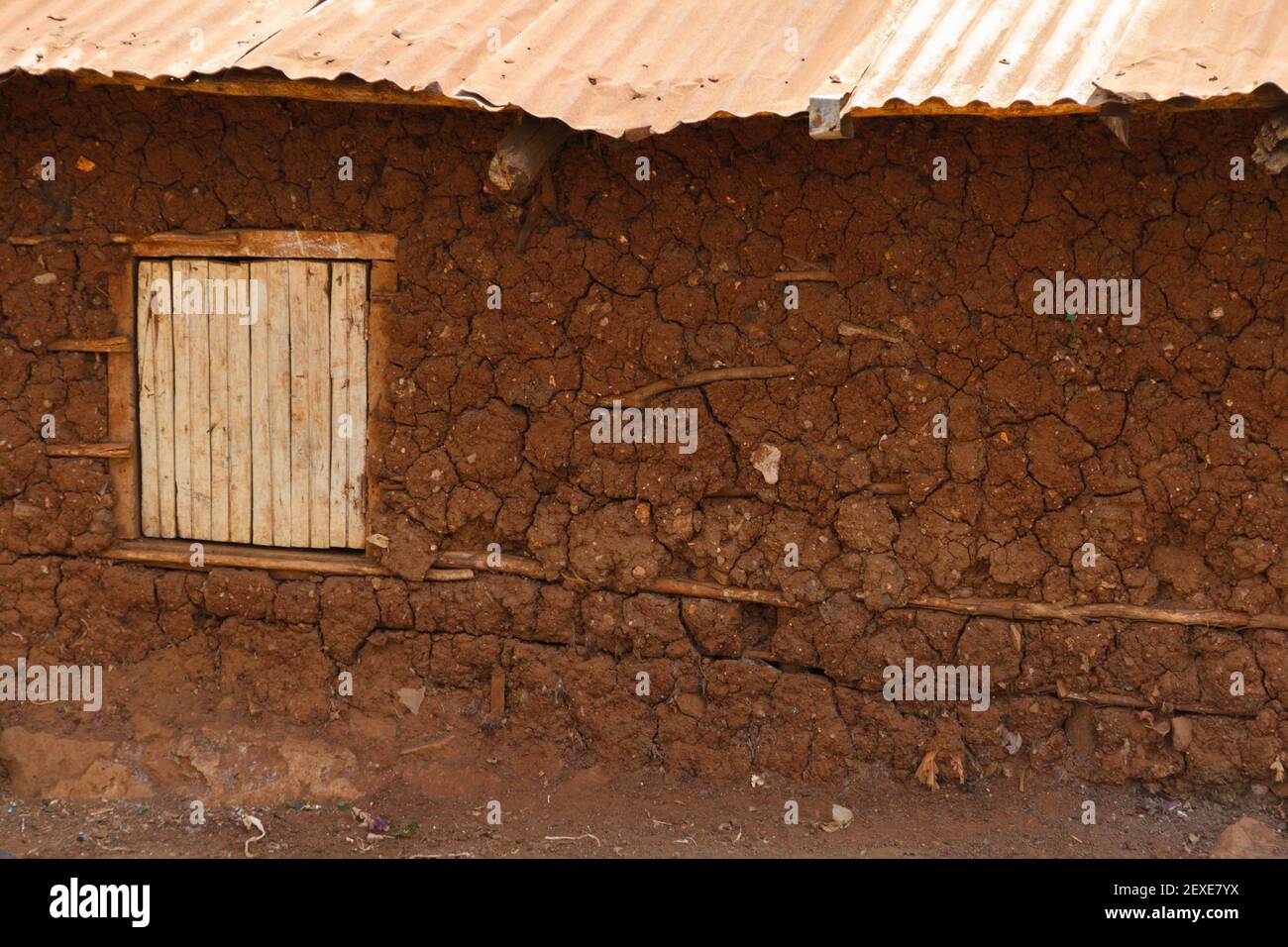 A mud hut home with a window inside the Kibera slum of Nairobi, Kenya ...