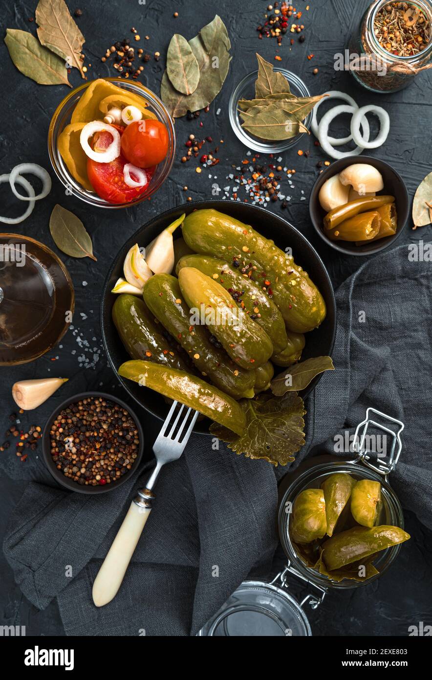 Delicious pickled cucumbers on a dark background. Homemade pickles with ...