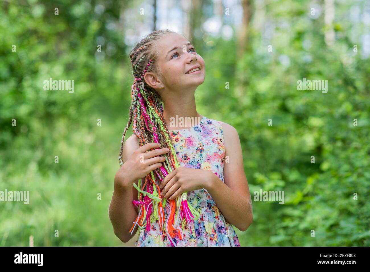 Teenage girl with multi-colored dreadlocks in the forest Stock Photo ...