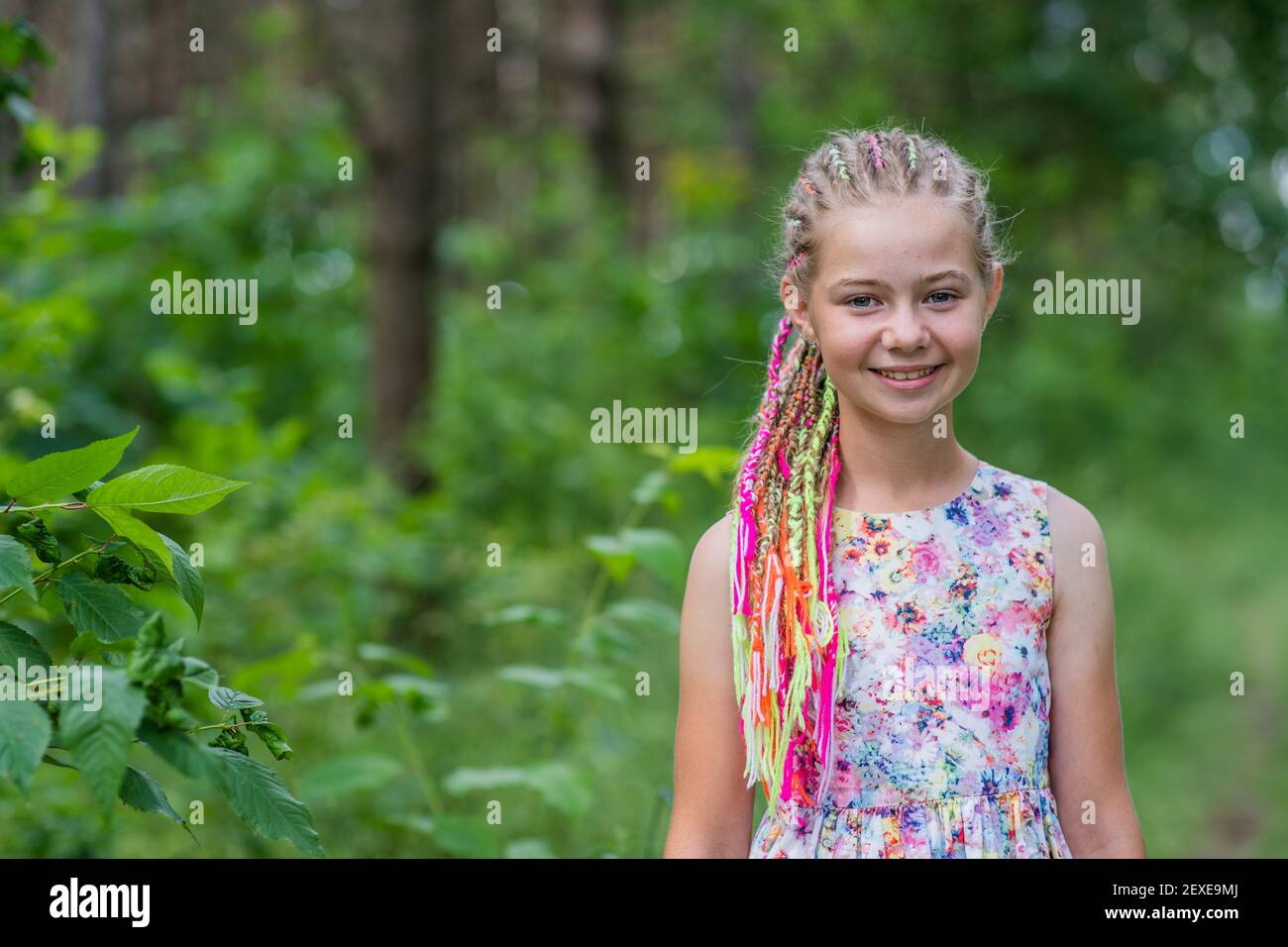Teenage girl with multi-colored dreadlocks in the forest Stock Photo ...