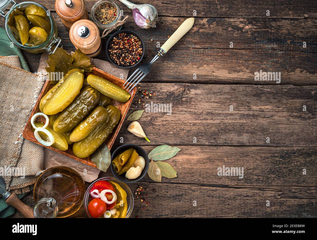 Crispy pickled cucumbers on a wooden brown background. Top view with ...