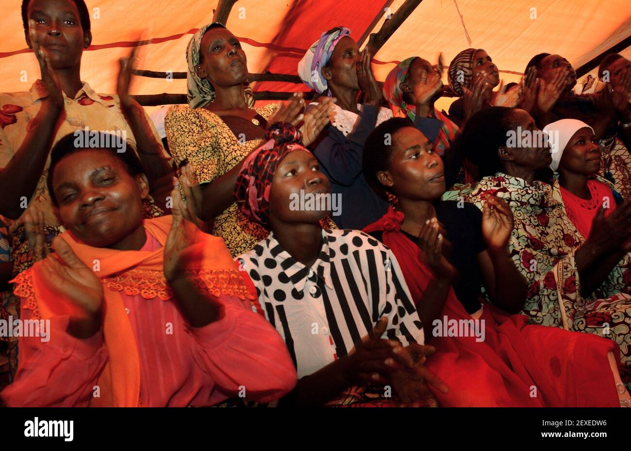 IN THE RWANDAN VILLAGE OF KABUGA,VILLAGERS WATCH DANCING IN CELEBRATION ...