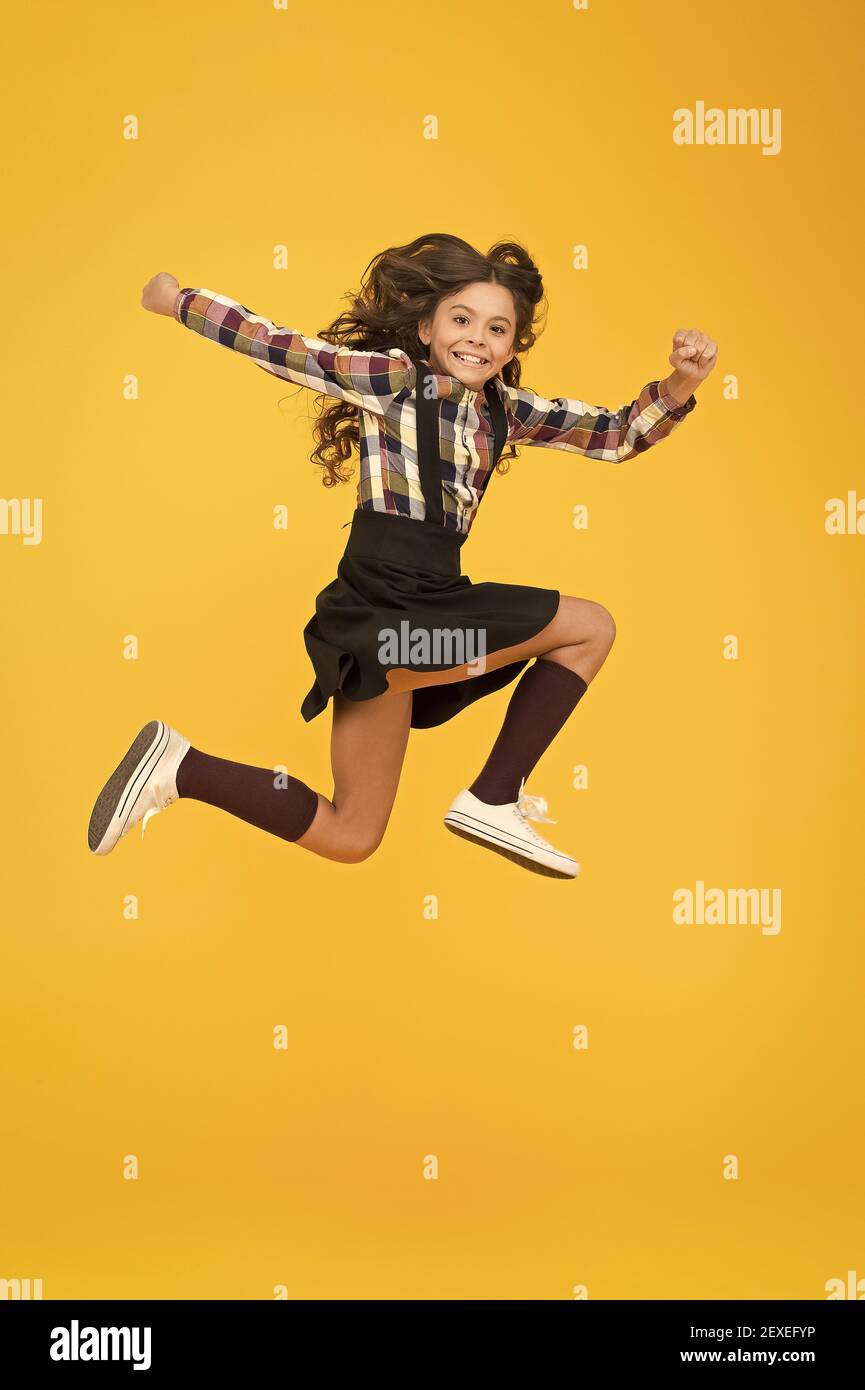 Be happy everyday. Happy child in midair yellow background. Having fun ...
