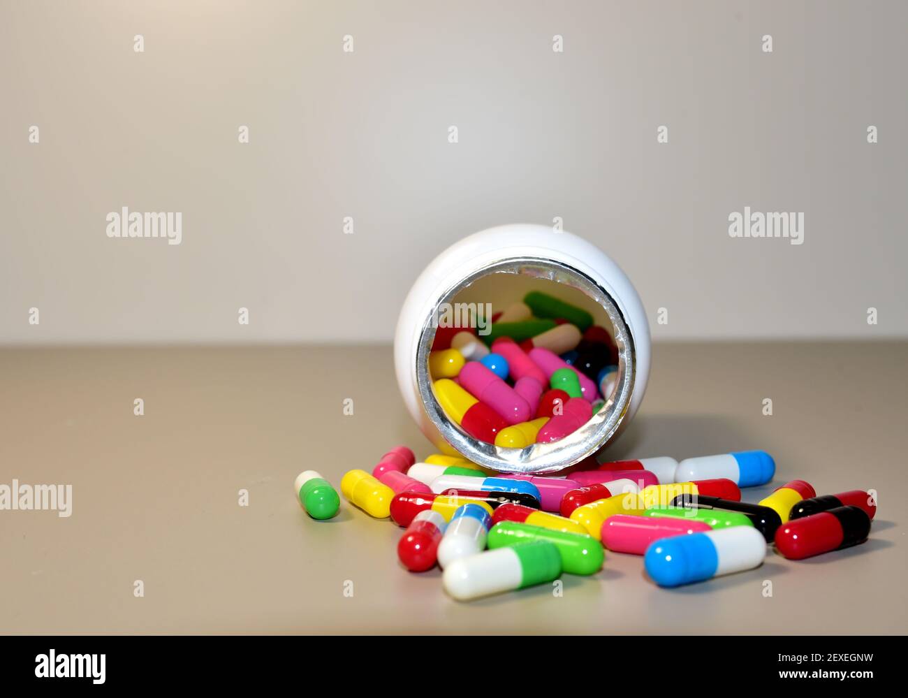 Pills from a bottle on wooden background. Assorted pharmaceutical pills ...