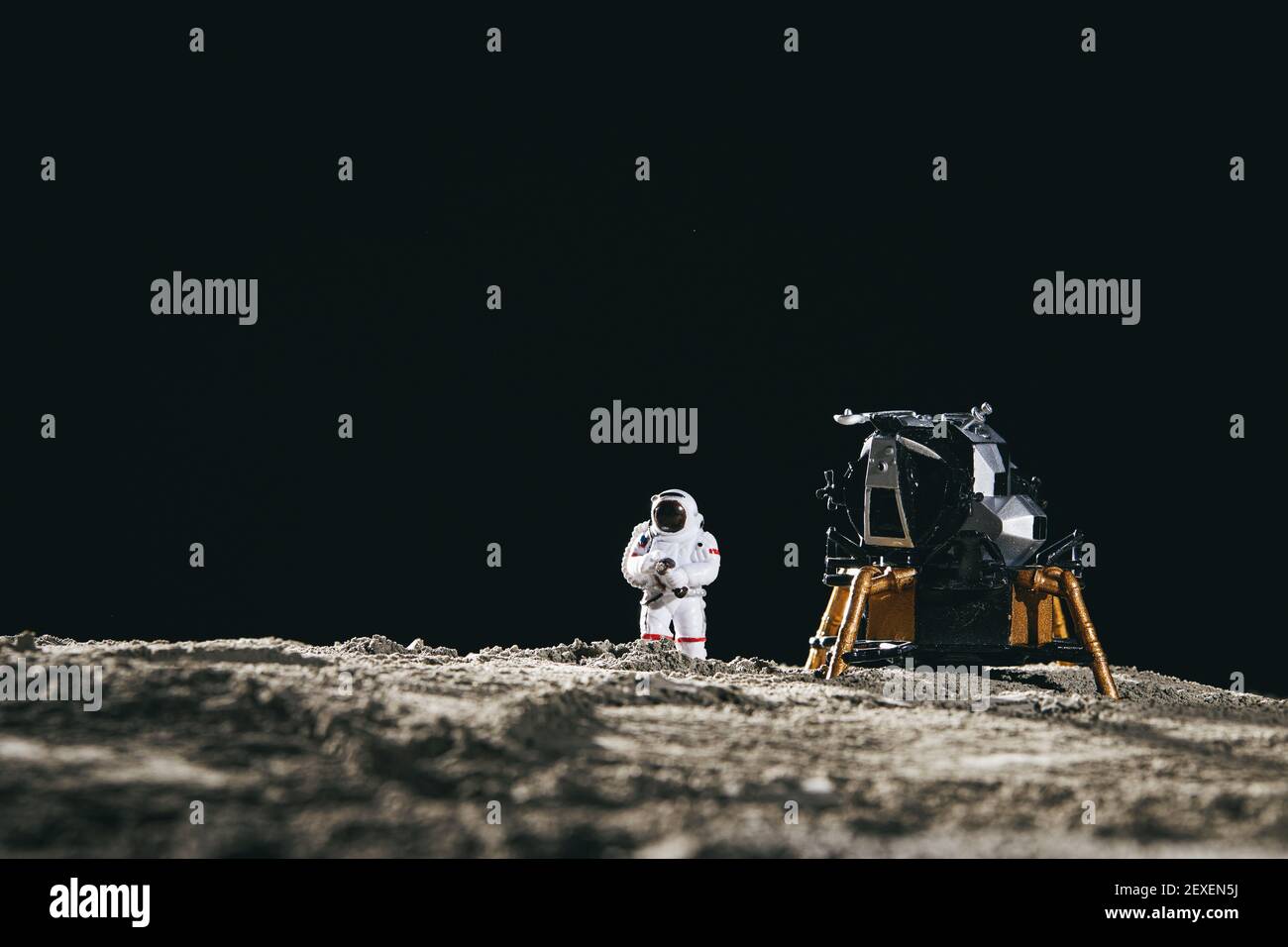 An astronaut miniature toy next to a spaceship on the moon Stock Photo ...