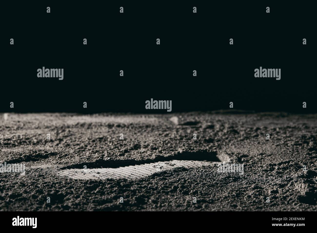 A footprint on the moon against a black background Stock Photo - Alamy