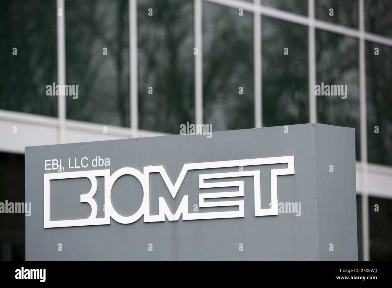 A logo sign outside of a facility occupied by Zimmer Biomet in ...