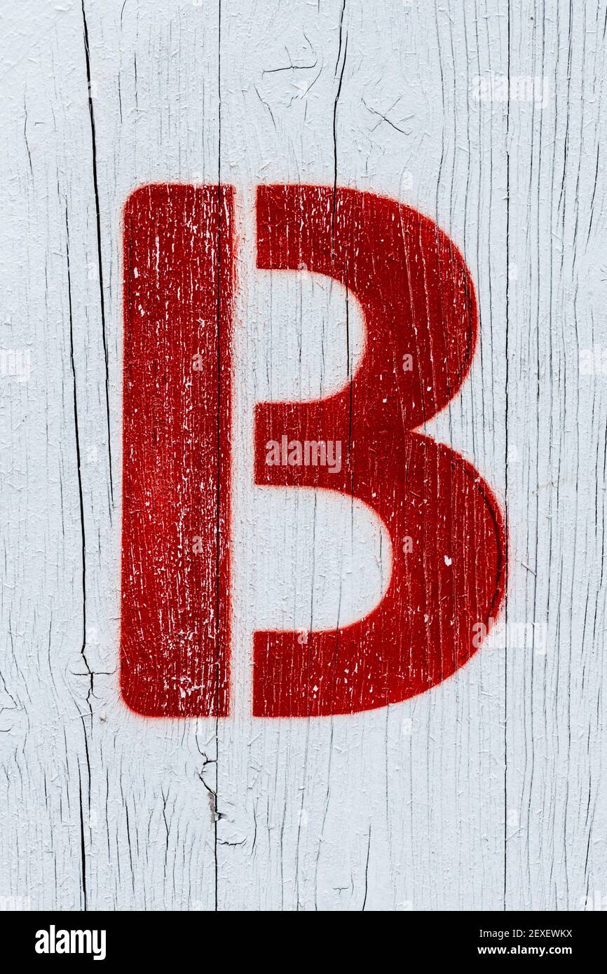 Red B sprayed on white painted wooden boards Stock Photo - Alamy