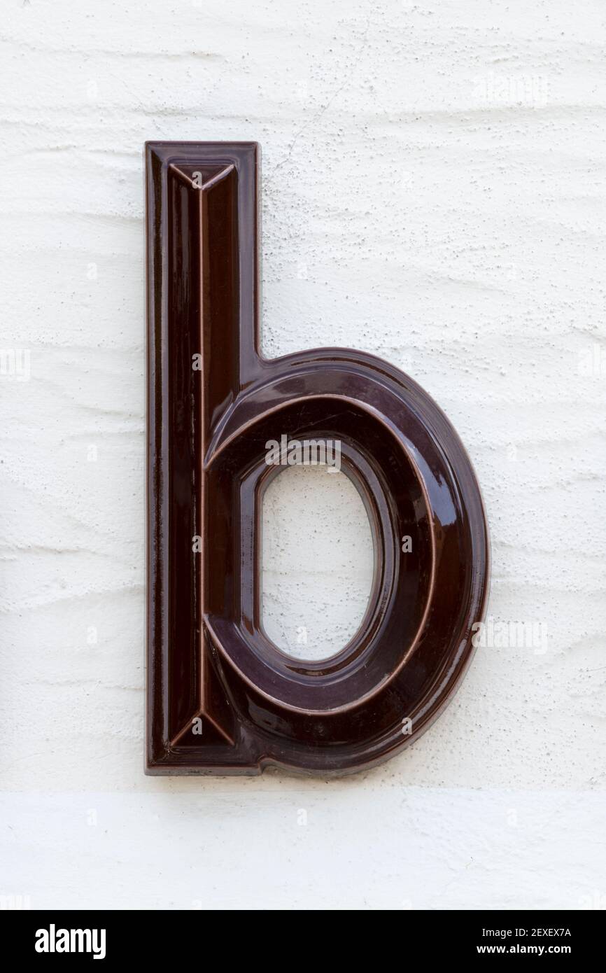 Dark brown glazed letter b on a light wall Stock Photo - Alamy