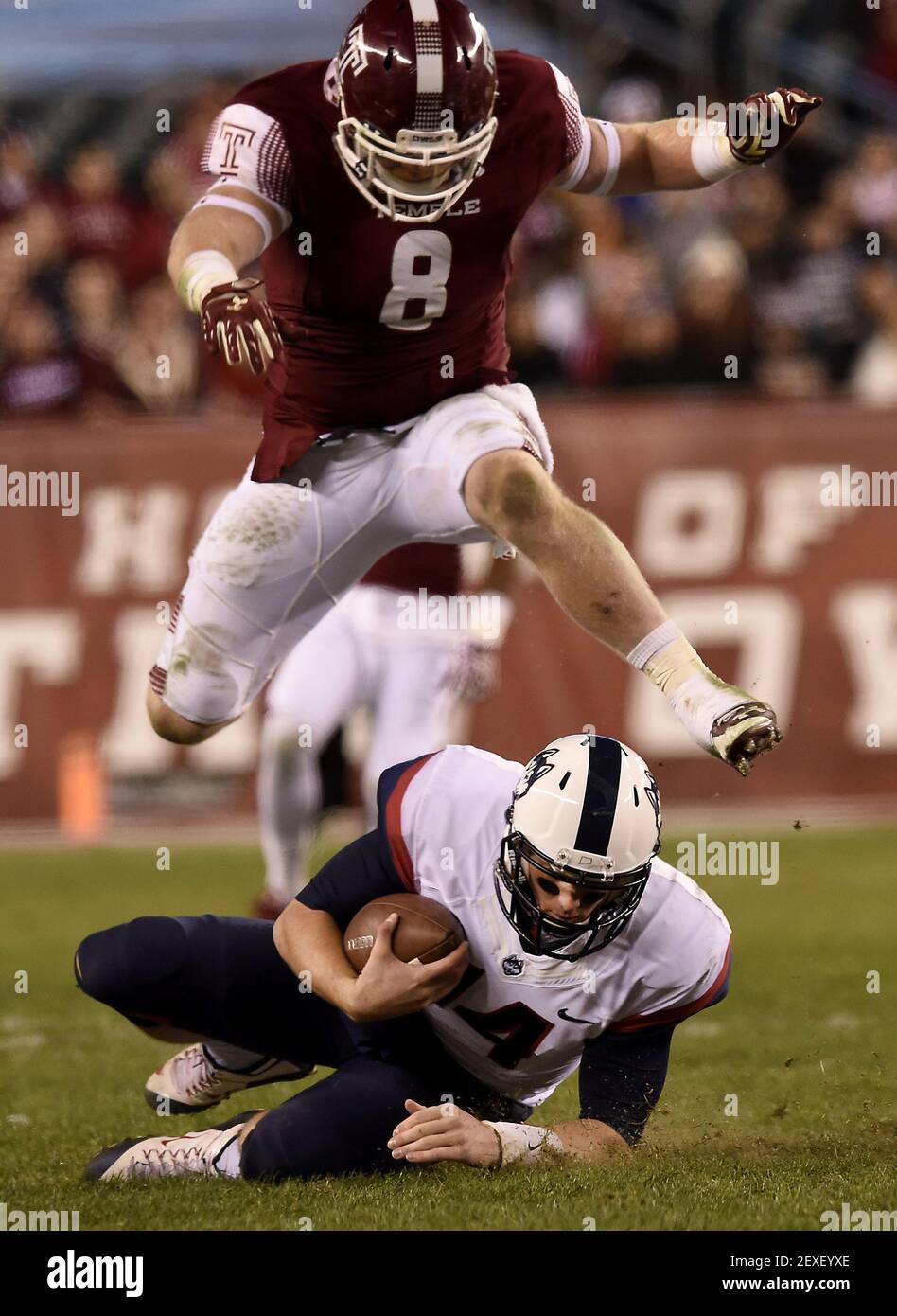 Connecticut quarterback Tim Boyle (14) slides to the turf after picking ...