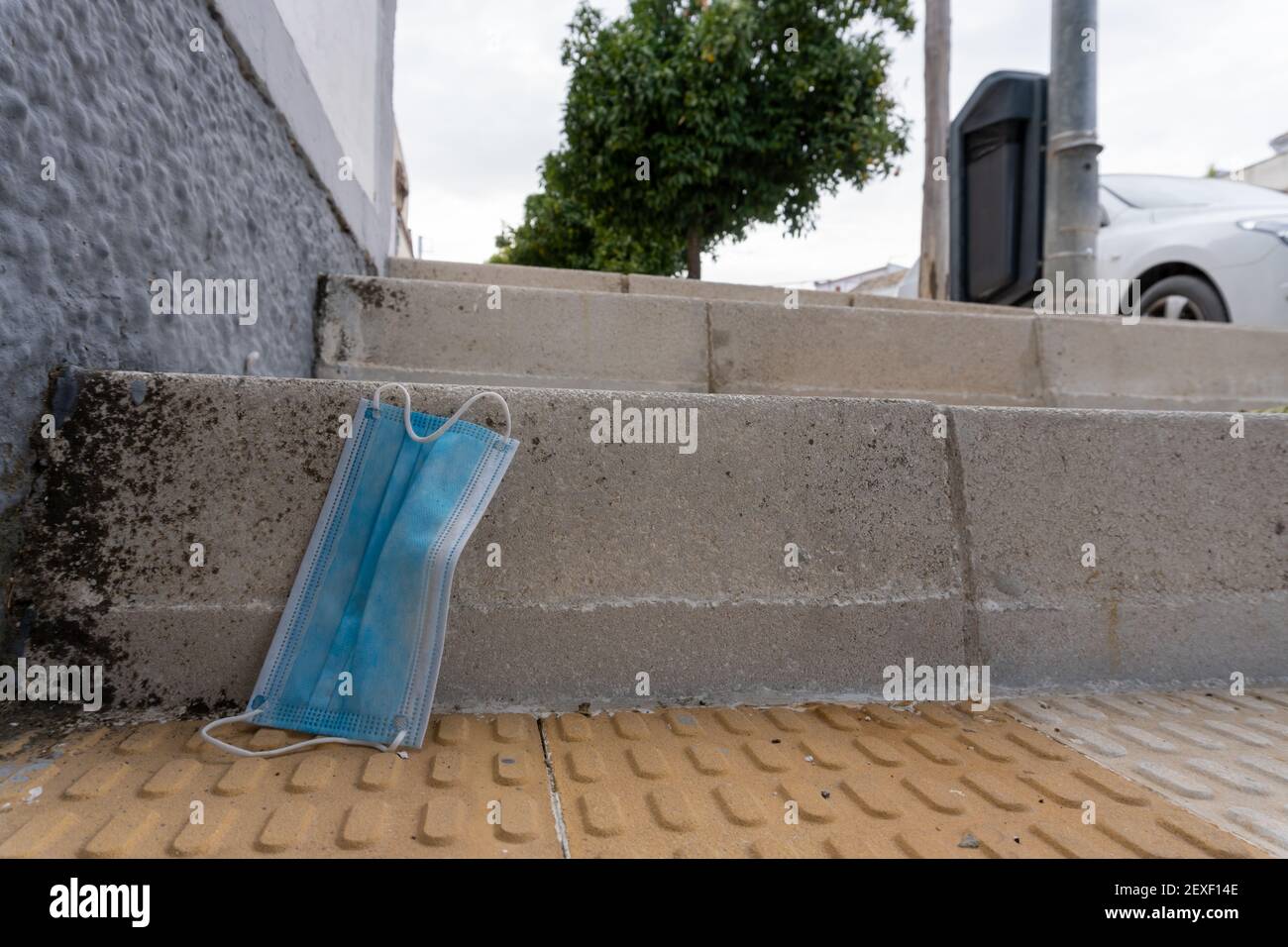 Stock photo of disposable face mask thrown in the floor. Pollution ...