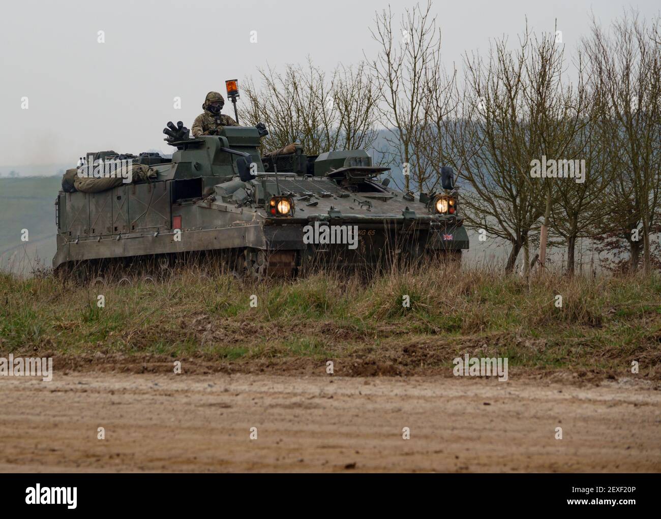 british army FV512 warrior MRV tank kicking up clouds of dust on ...