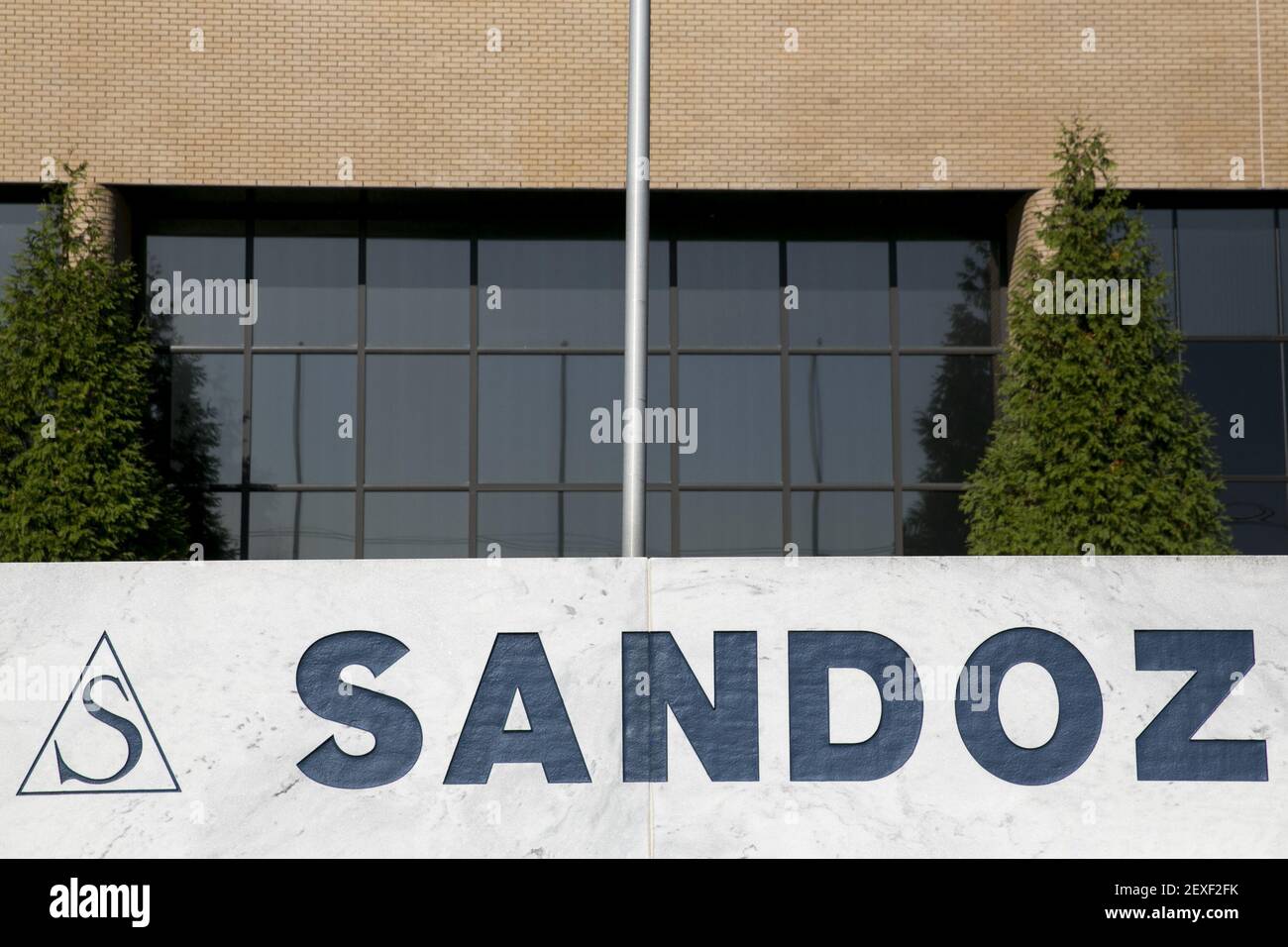 A logo sign outside of the headquarters of Sandoz Pharmaceuticals in ...