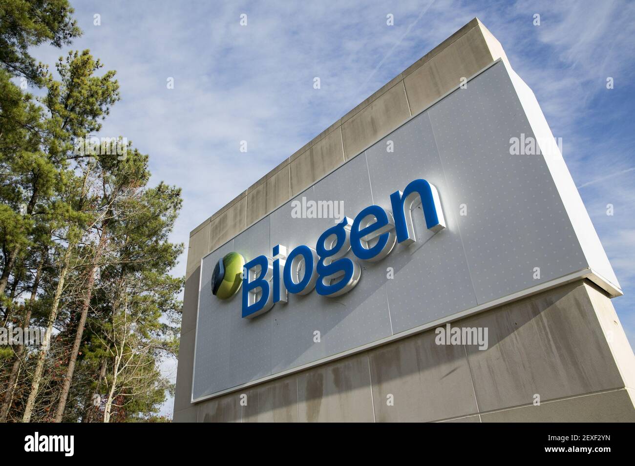 A logo sign outside of a facility occupied by Biogen in Research ...