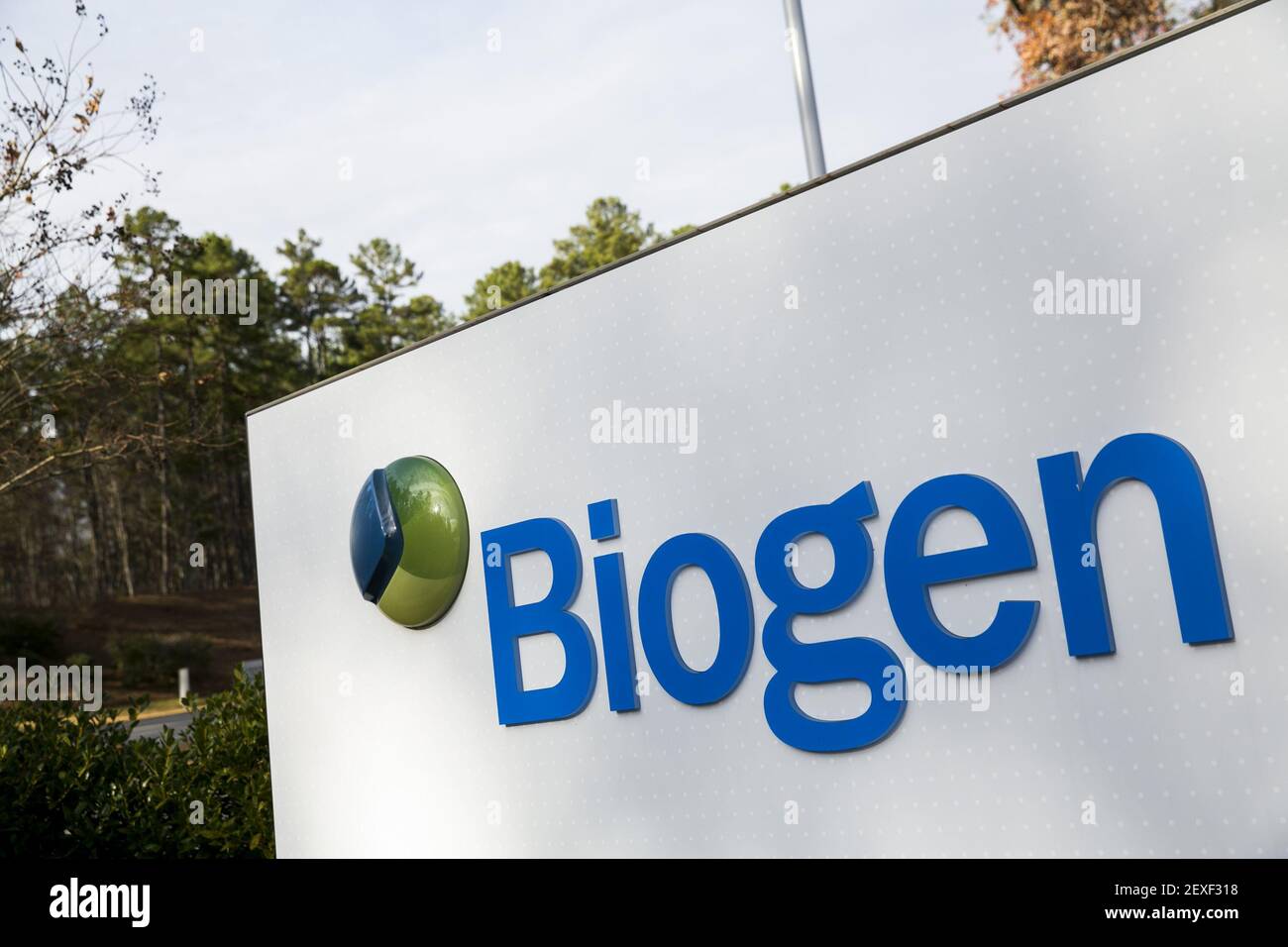 A logo sign outside of a facility occupied by Biogen in Research ...