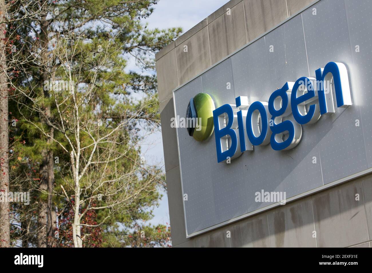 A logo sign outside of a facility occupied by Biogen in Research ...