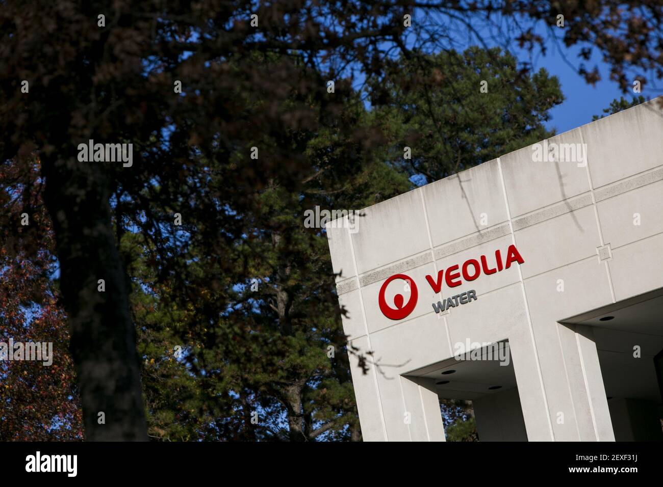 A logo sign outside of a facility occupied by Veolia Water in Cary ...
